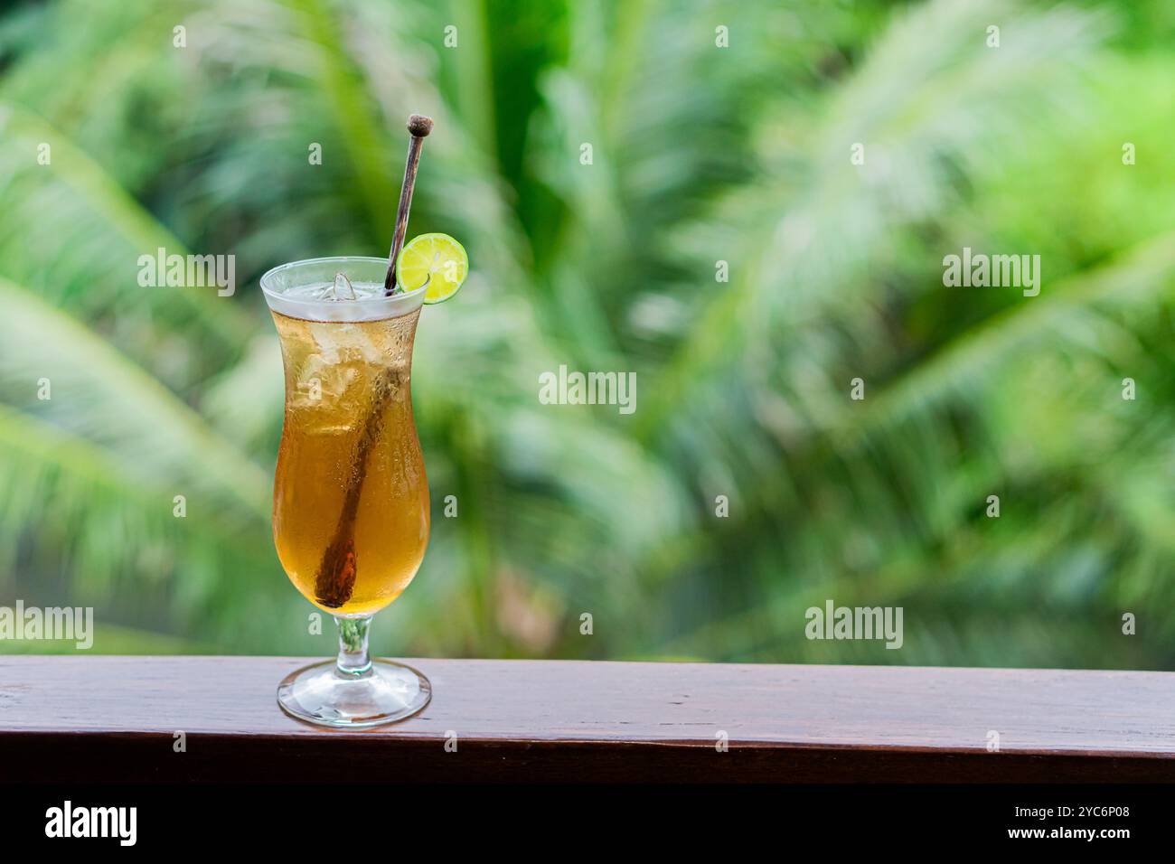 A refreshing cocktail served in a tall glass, garnished with a lime ...