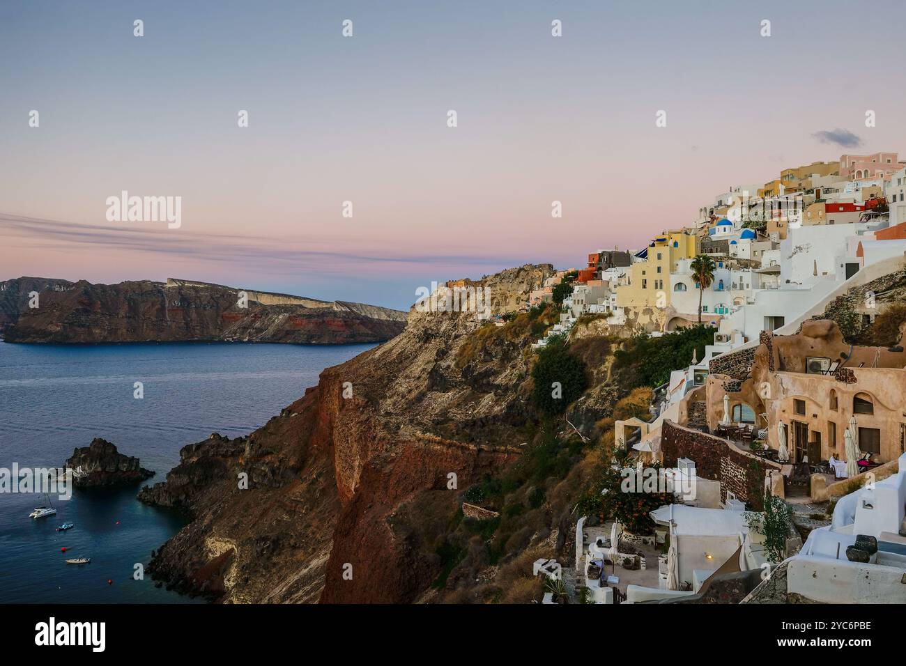 View of Oia in Santorini, Greece, at dusk, showcasing the caldera ...
