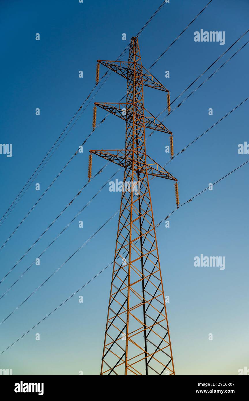 This is a shot of a high-voltage electric transmission tower, also ...