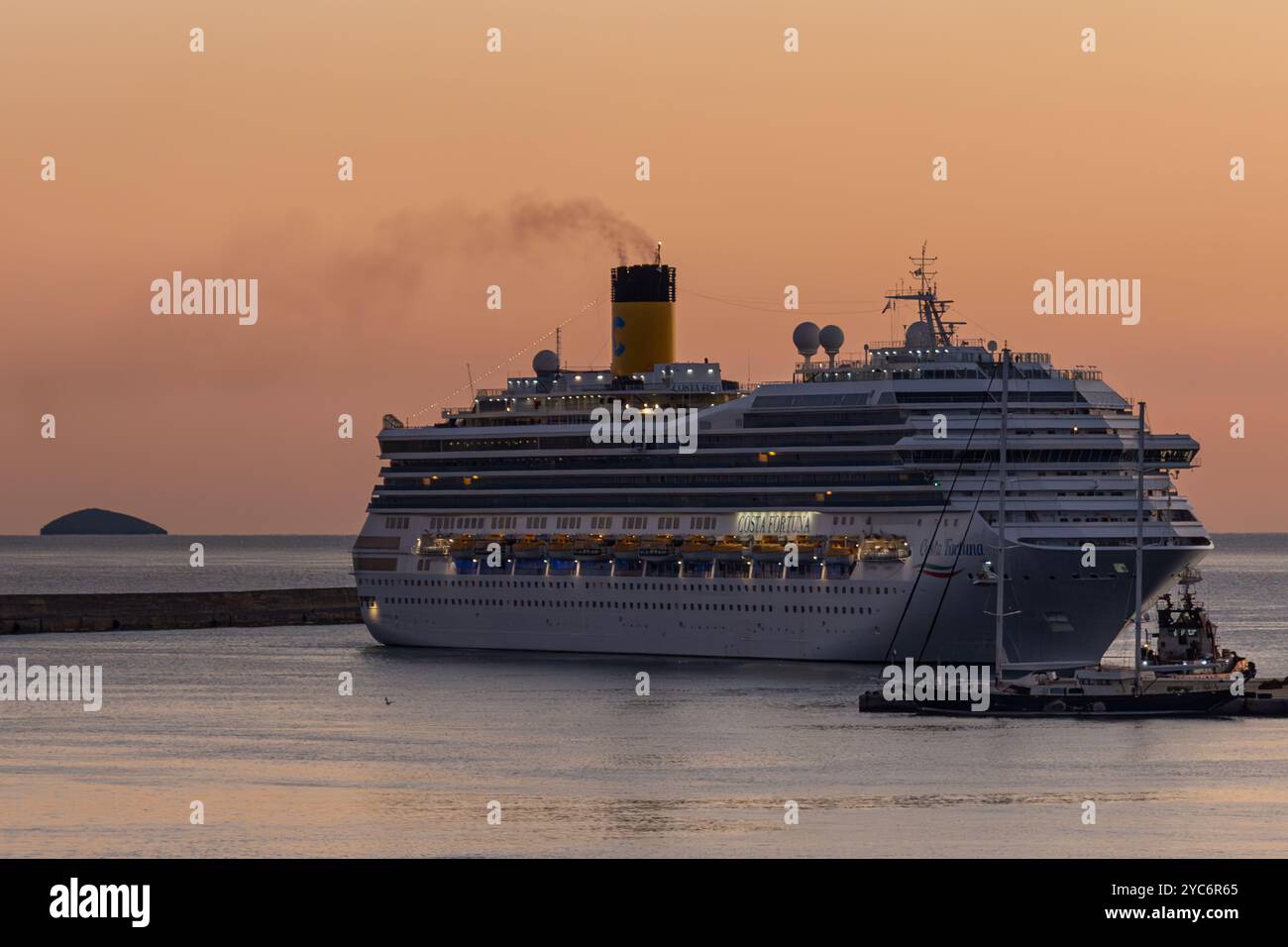 Cruise ship leaving the port under a sunset sky with hi-res stock ...