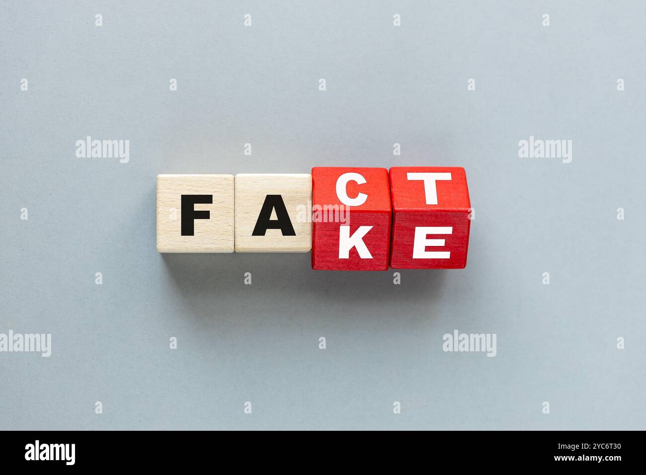 Fact and Fake. The rotating dice change the word fact to fake. Flat lay ...