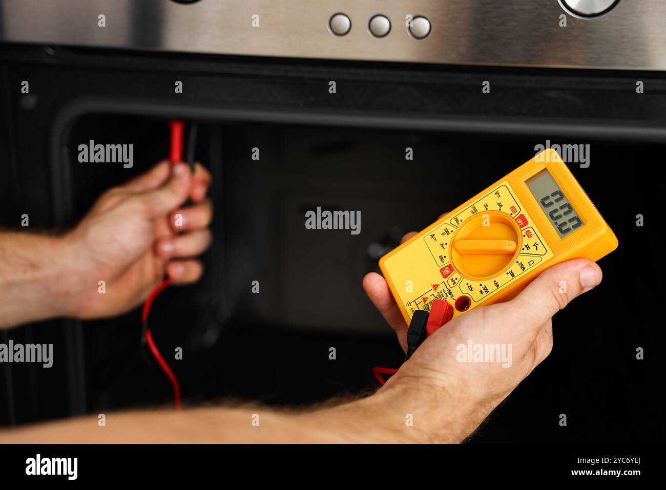 Repairman testing oven element with multimeter, closeup Stock Photo - Alamy