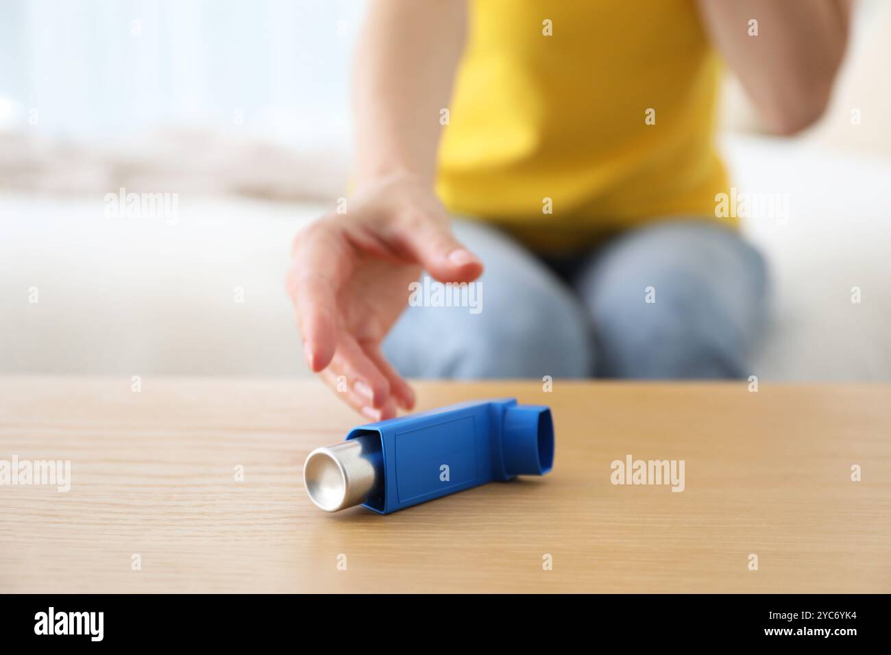 Young woman using asthma inhaler at home, selective focus Stock Photo ...