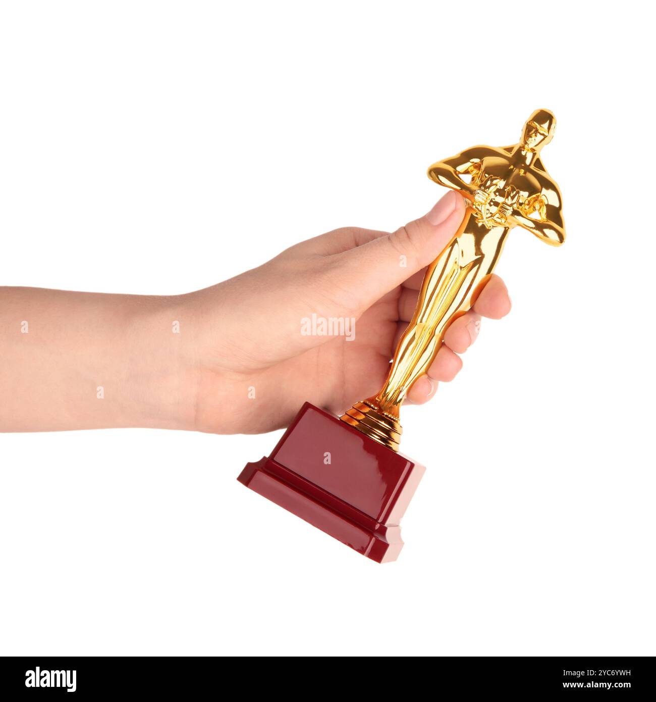 Woman holding golden trophy in shape of human figure against white ...