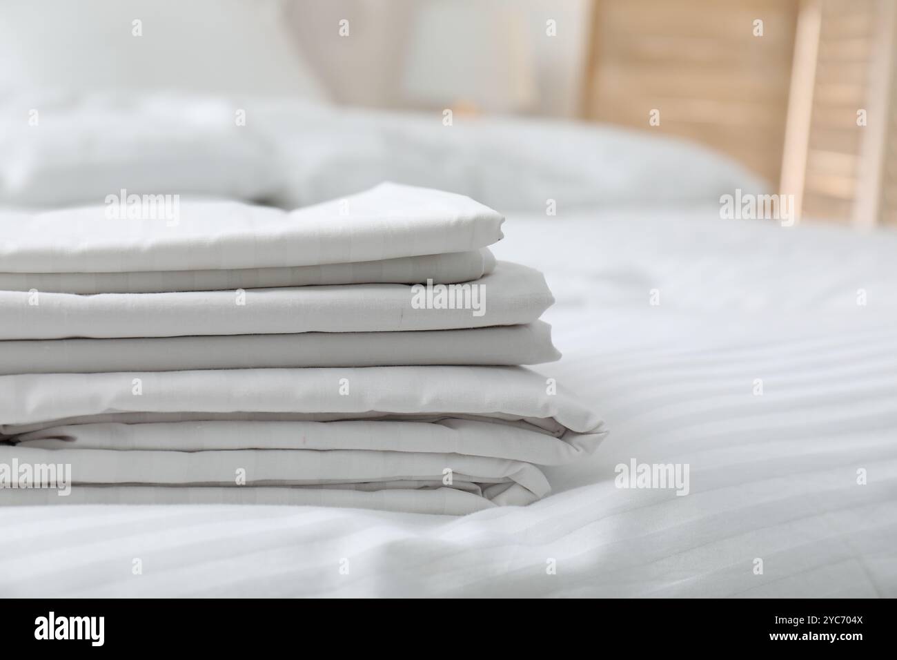 Stack of clean linens on bed indoors, closeup Stock Photo - Alamy