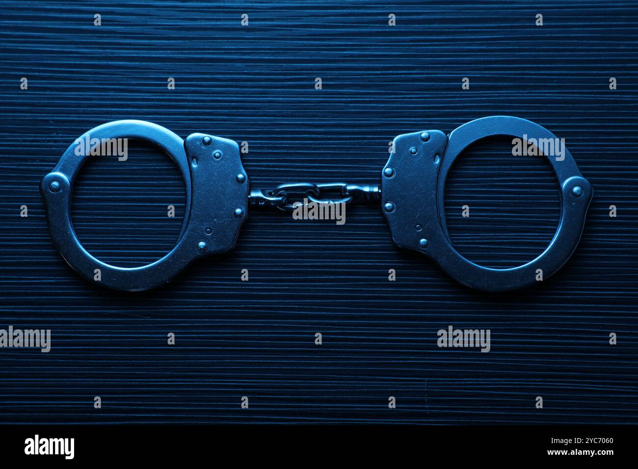 Classic chain handcuffs on table, top view Stock Photo - Alamy
