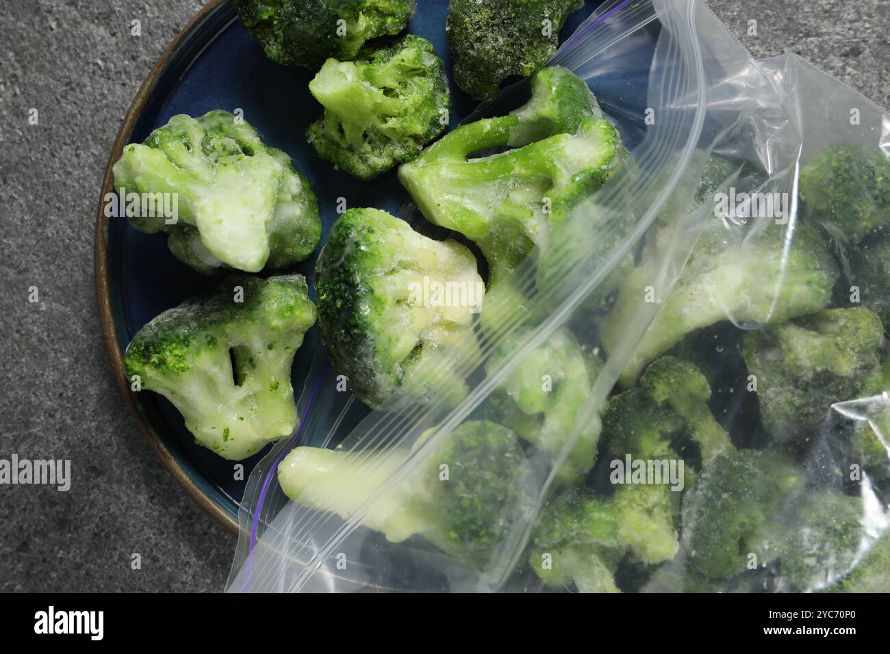Frozen broccoli out of plastic bag on grey table, top view Stock Photo ...