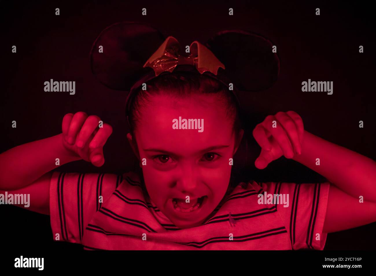 Young girl with halloween headband posing with a scary face Stock Photo ...
