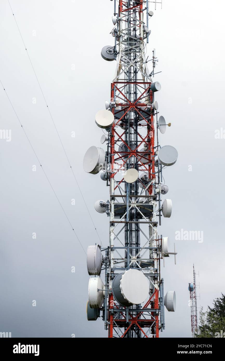 A tall tower dominates the skyline, bristling with an array of antennas ...