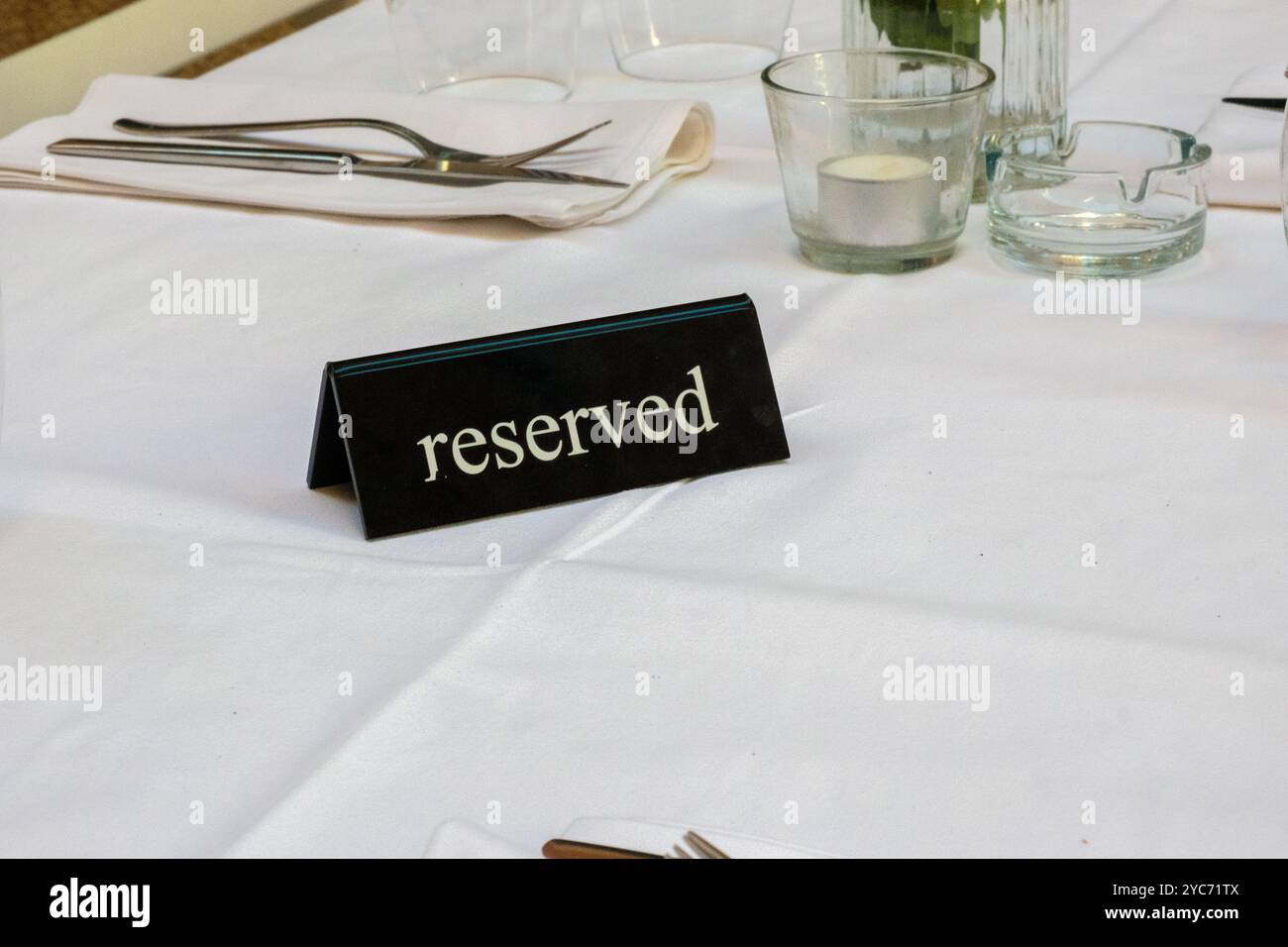 Reserved label on the table of an outdoor restaurant in an Italian city ...