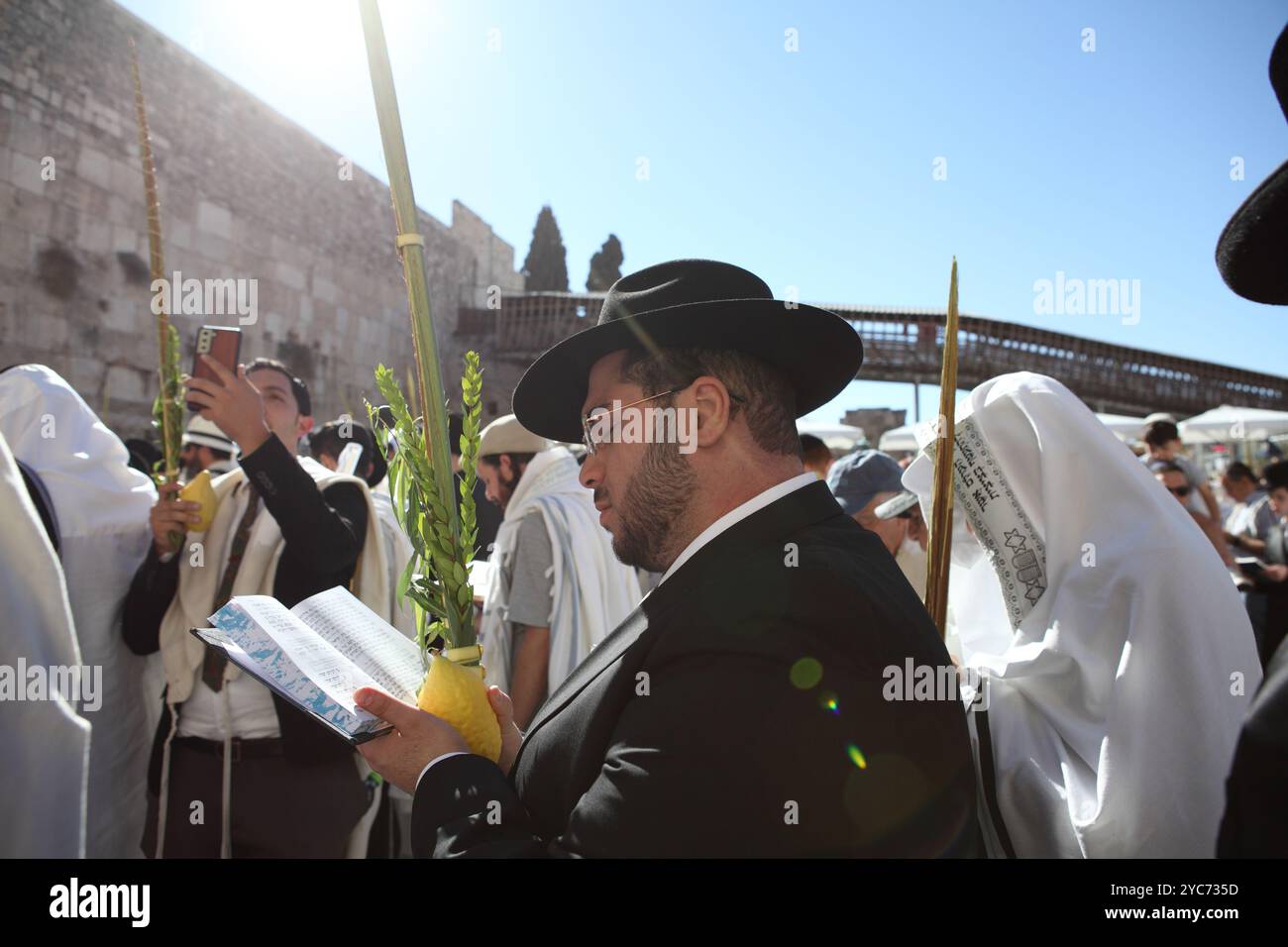 Crowd of Jewish men with prayer shawls or Talith pray at the Western ...