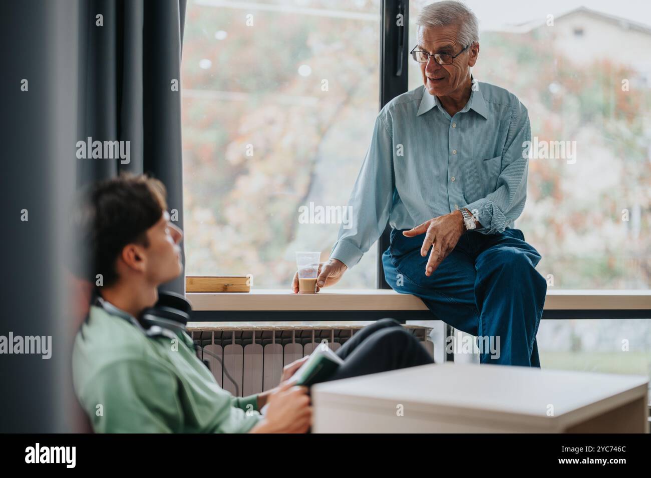 Professor engaging with students in a relaxed classroom setting Stock ...