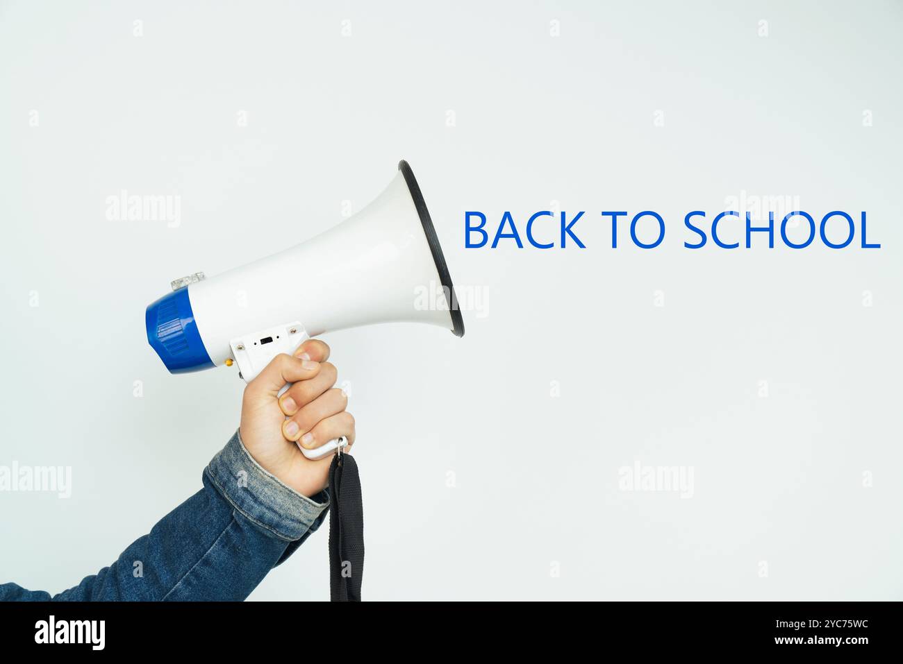 hand holding megaphone and back to school text Stock Photo - Alamy