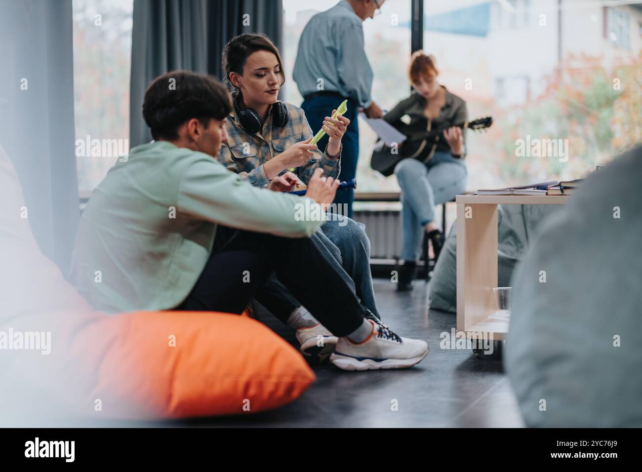 College students engaging in a collaborative music class session Stock ...