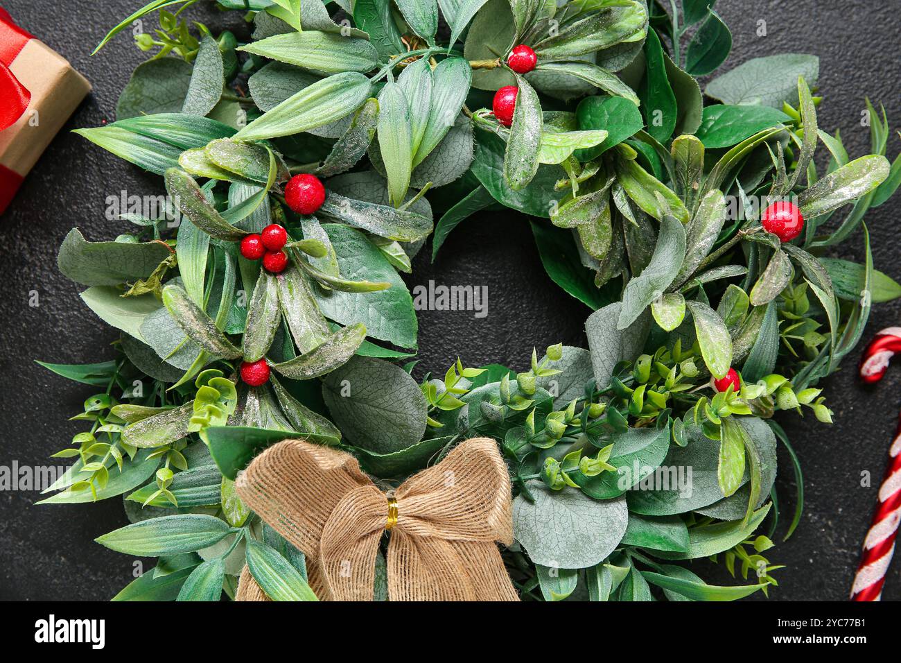 Beautiful mistletoe wreath on black background Stock Photo - Alamy