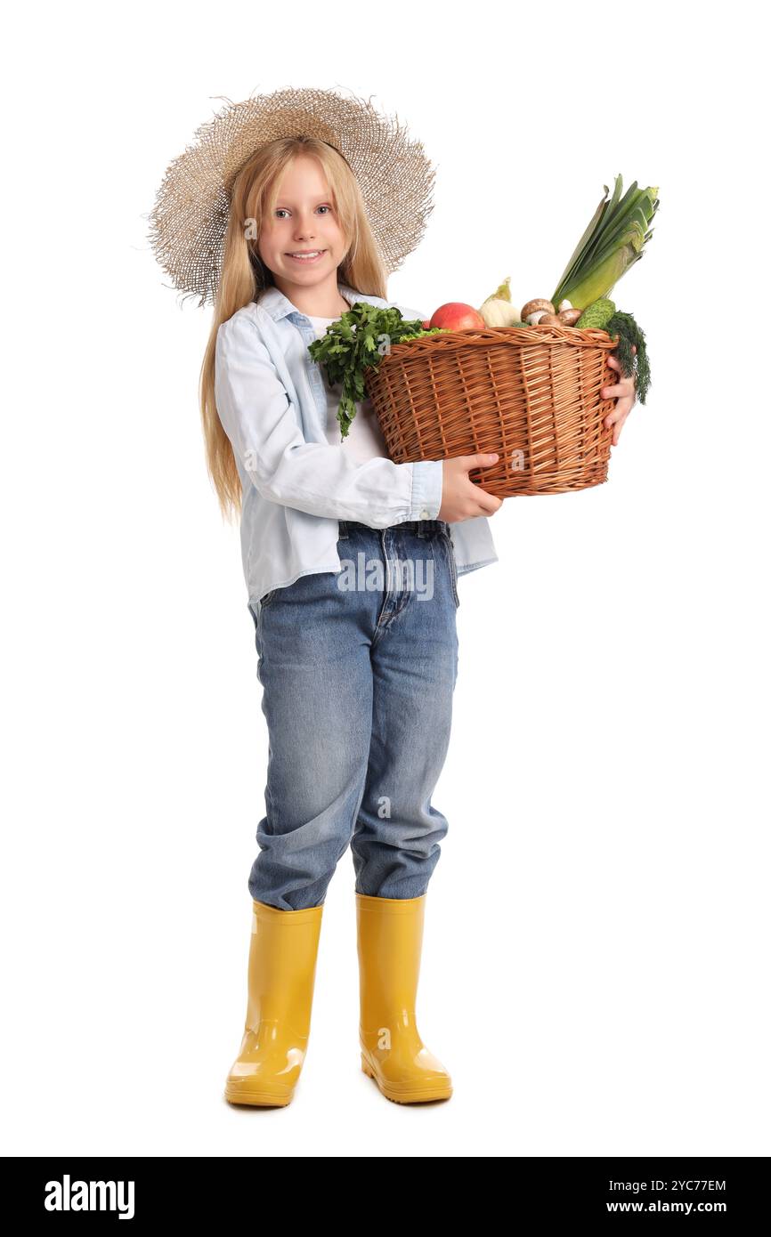 Little farmer with fresh food on white background Stock Photo - Alamy