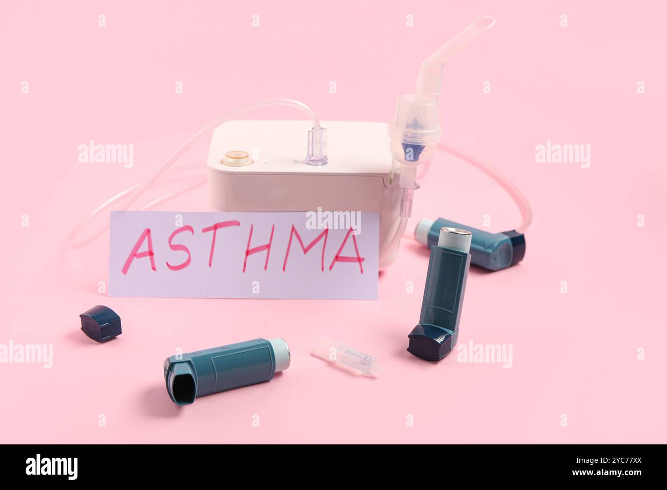 Modern inhalers with word ASTHMA on pink background Stock Photo - Alamy