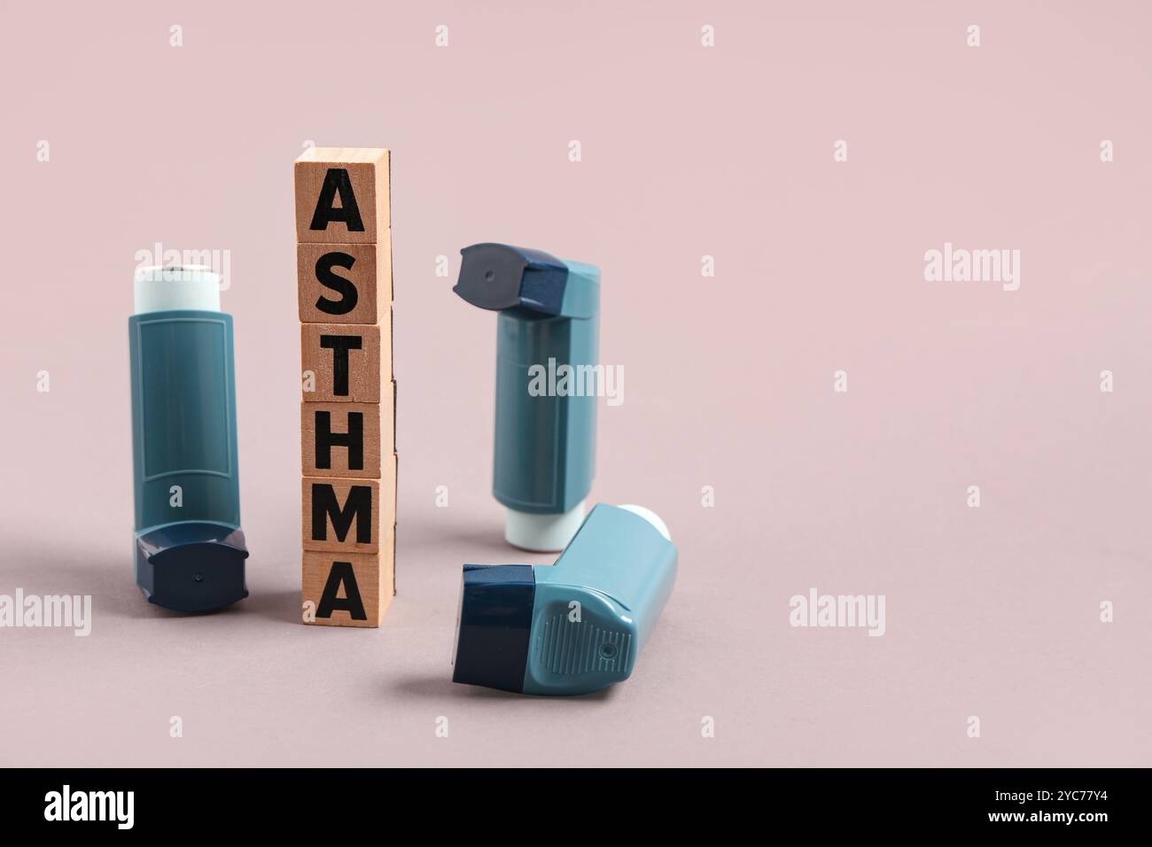 Modern inhalers and word ASTHMA on grey background Stock Photo - Alamy