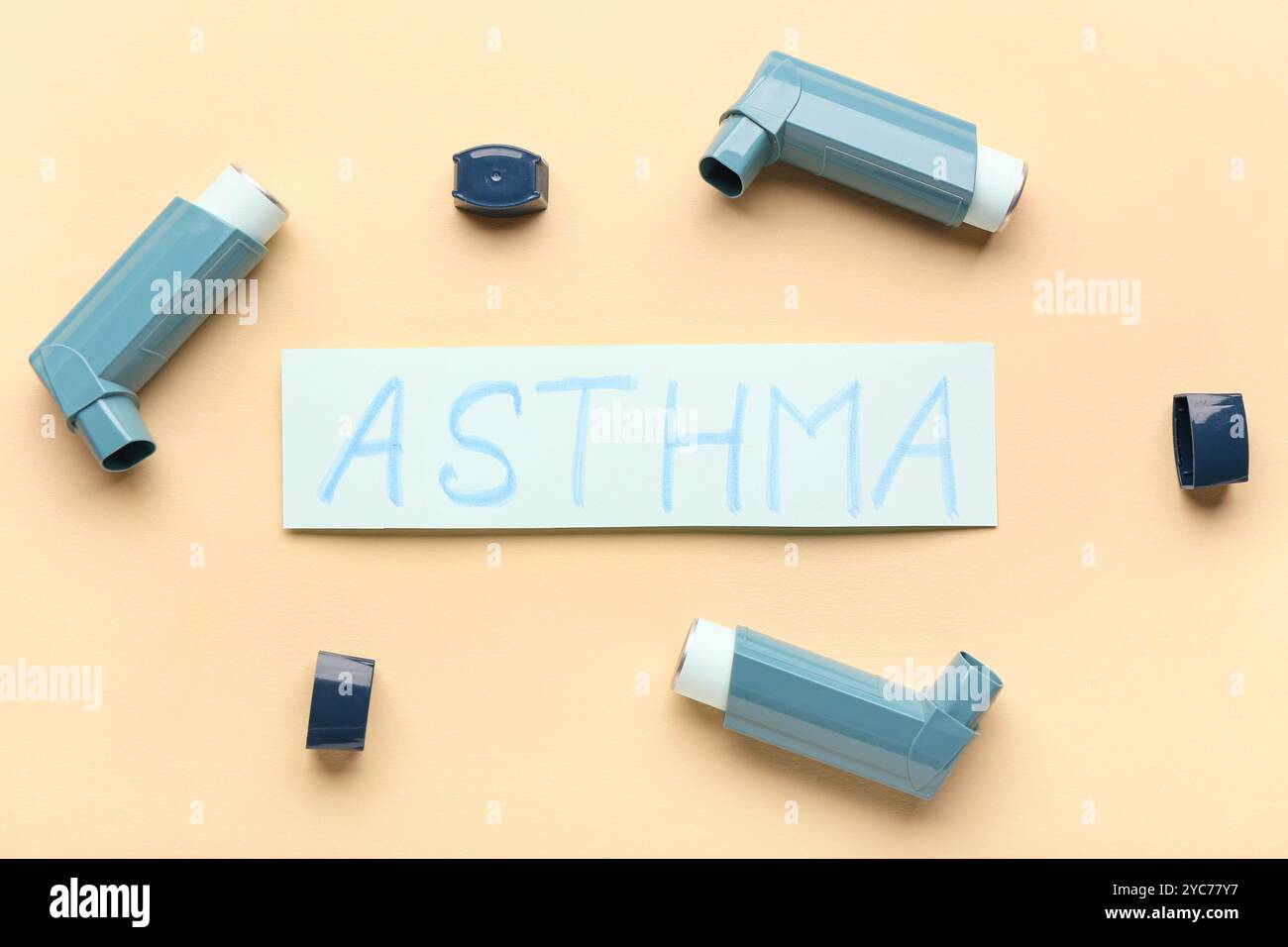 Inhalers and paper sheet with text ASTHMA on beige background Stock ...