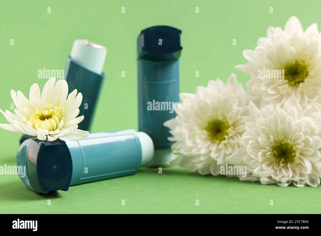 Modern inhalers and chrysanthemum flowers on green background Stock ...