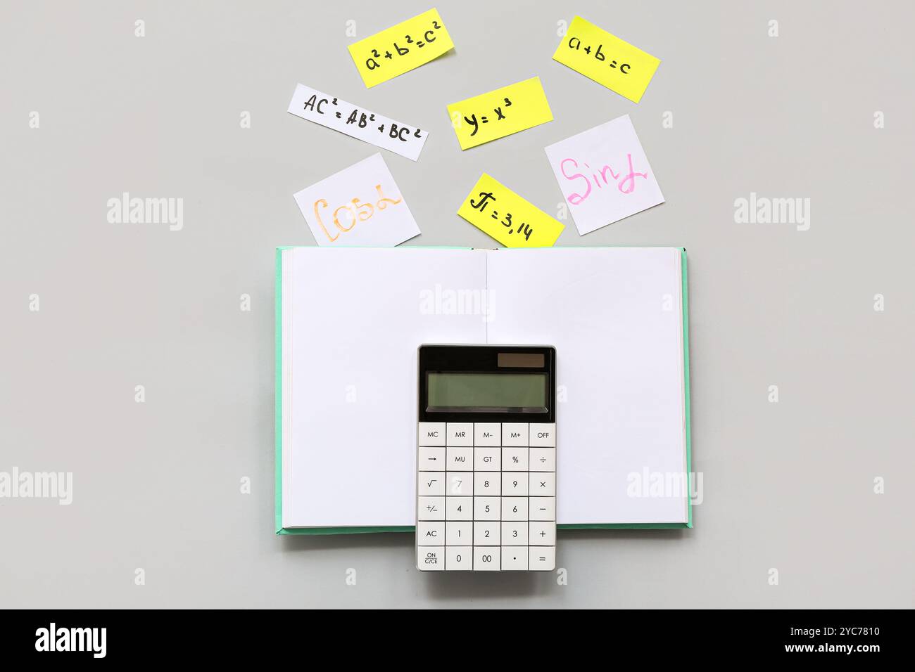 Notebook, calculator, different math formulas and equations on grey ...