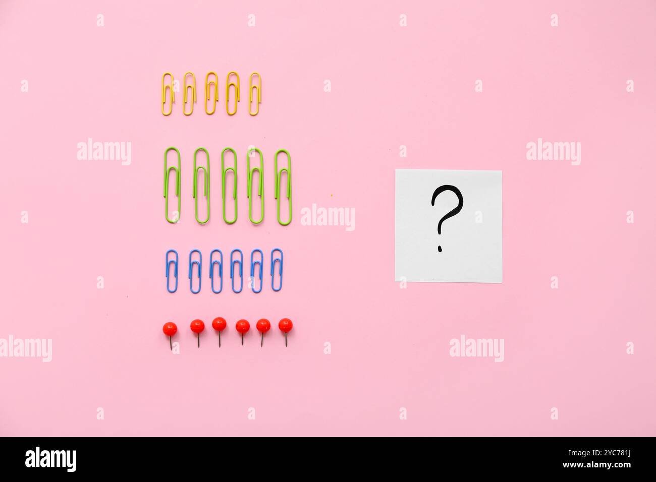 Paper clips with pins and question mark on pink background Stock Photo ...