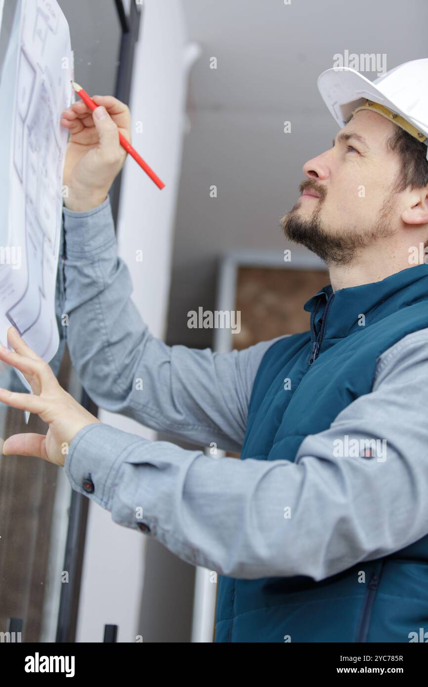 engineer with drawing maintenance work Stock Photo - Alamy