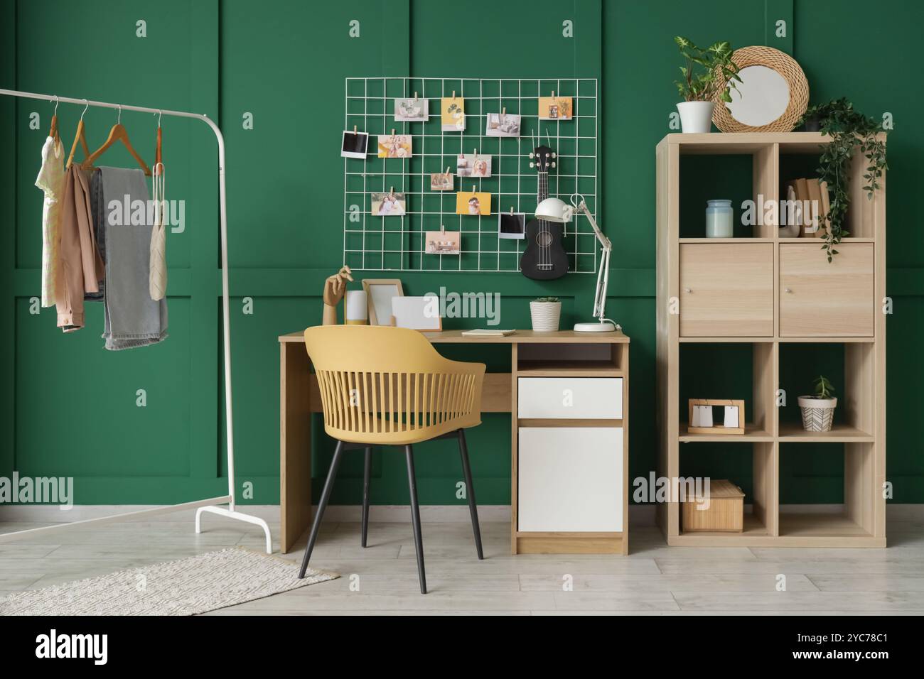 Interior of office with workplace, mood board and clothes rack Stock ...