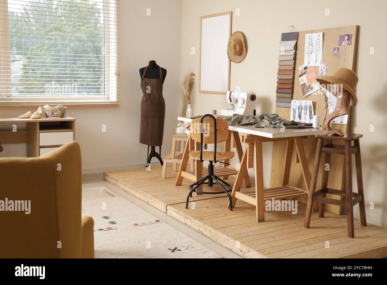Interior of stylish atelier with tailor's workspace, mannequin and mood ...