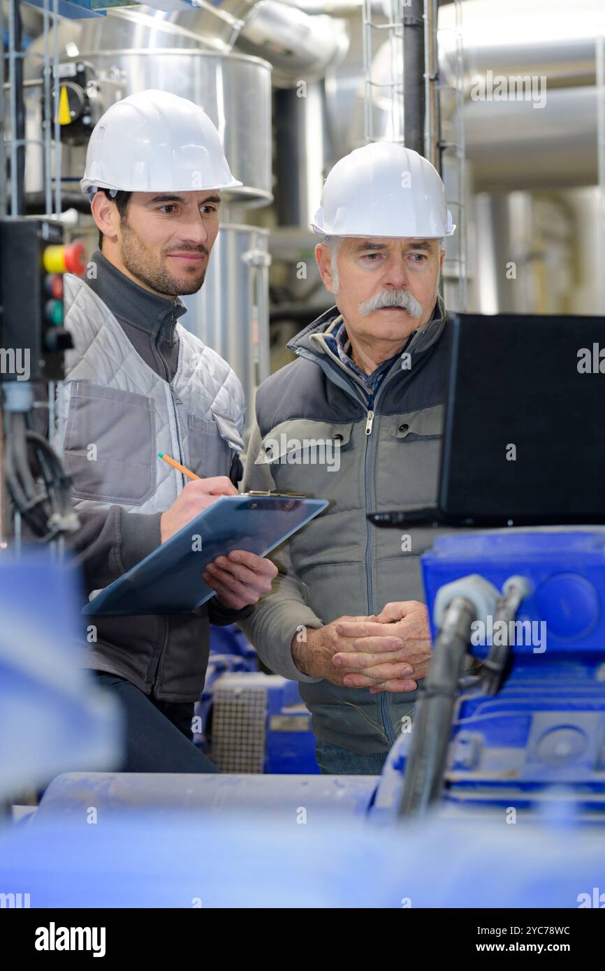 engineers of a facility monitoring a progress report Stock Photo - Alamy