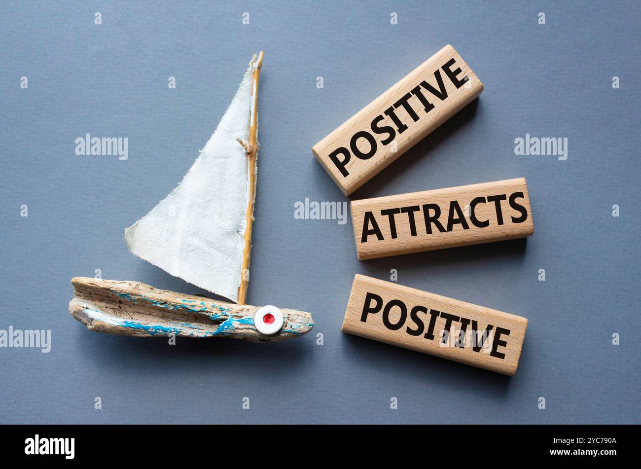 Positive attracts Positive symbol. Wooden blocks with words Positive ...