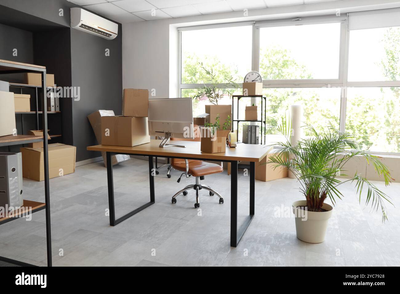Modern workplace with computer monitor and cardboard boxes in office on ...