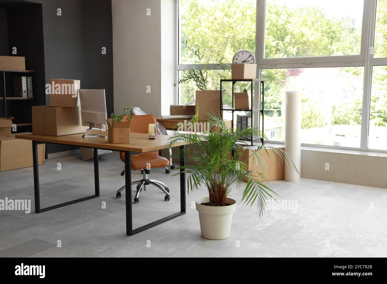 Modern workplace with computer monitor and cardboard boxes in office on ...