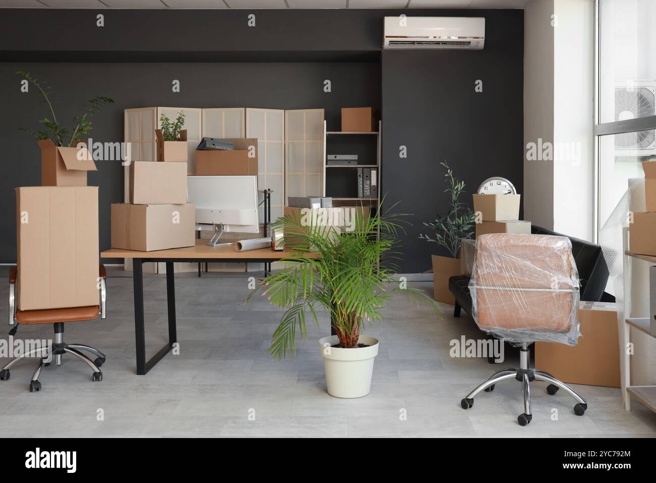 Modern workplace with chairs and cardboard boxes in office on moving ...