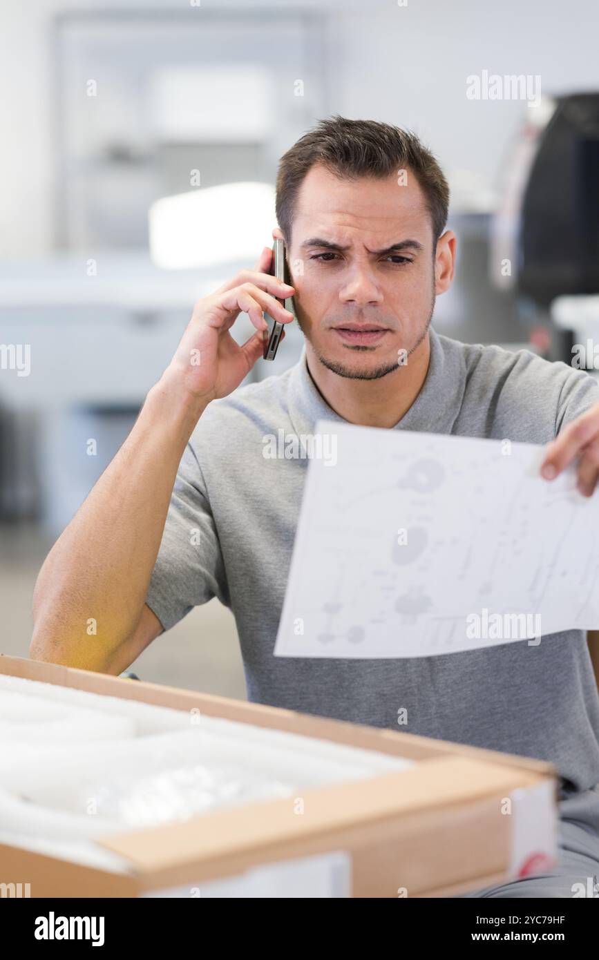 portrait of man checking architectural drawing on the phone Stock Photo ...