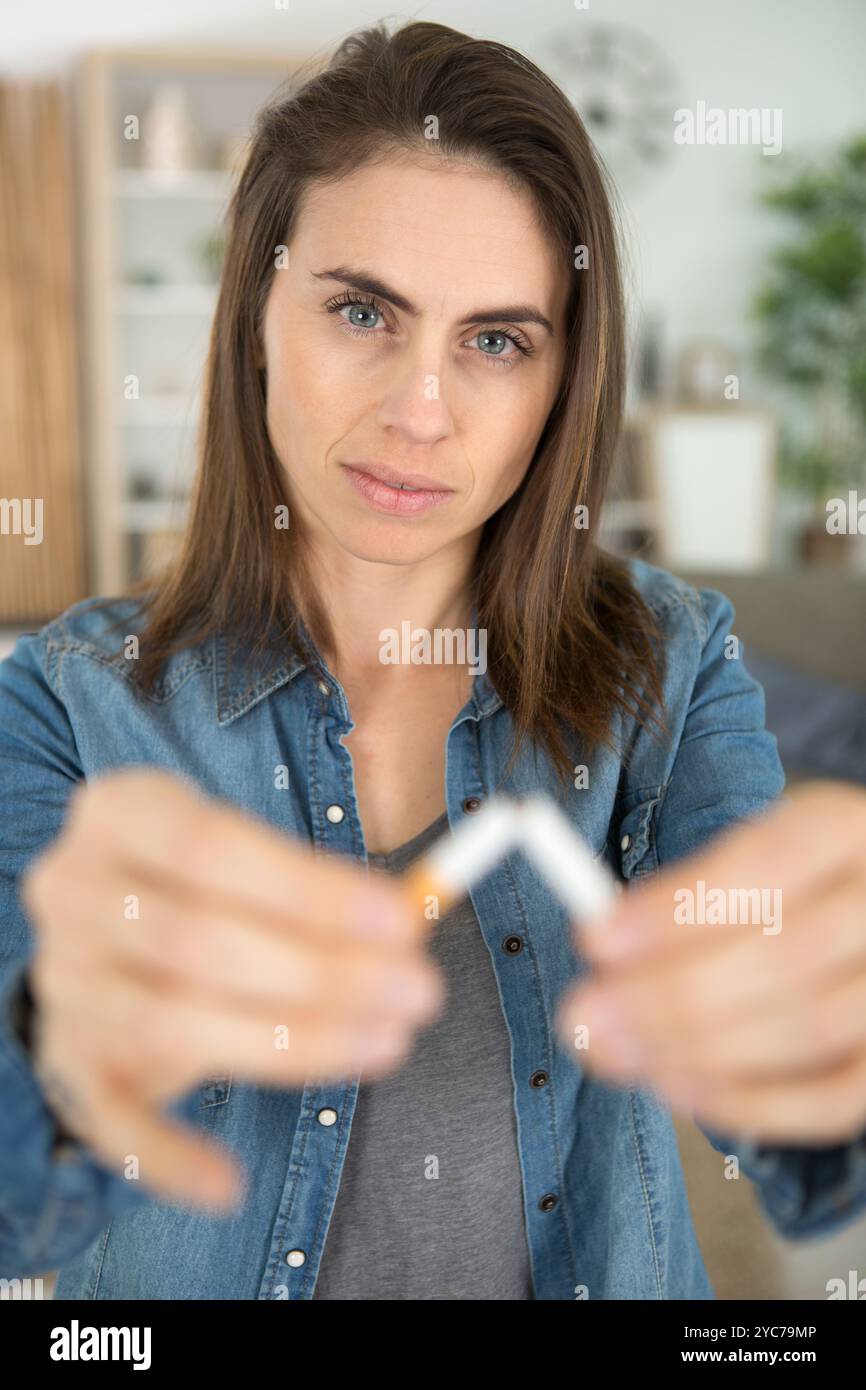 young woman breaks a cigarette Stock Photo - Alamy