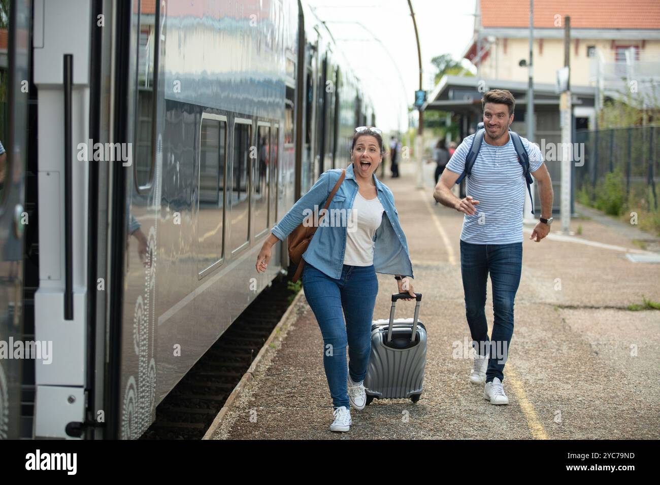 couple is late for the train at railway station Stock Photo - Alamy