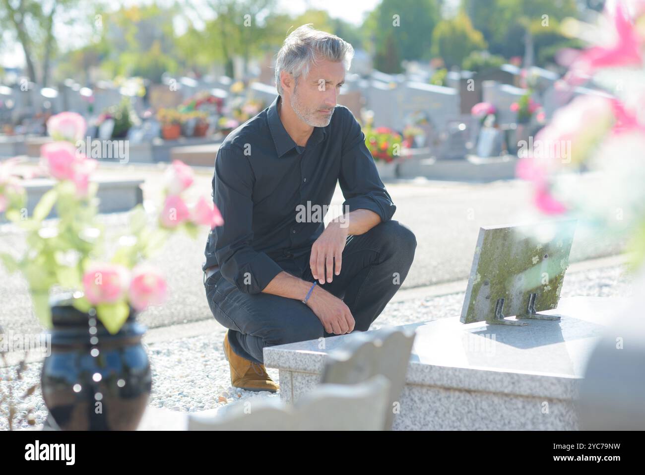 portrait of man man mourning at grave Stock Photo - Alamy