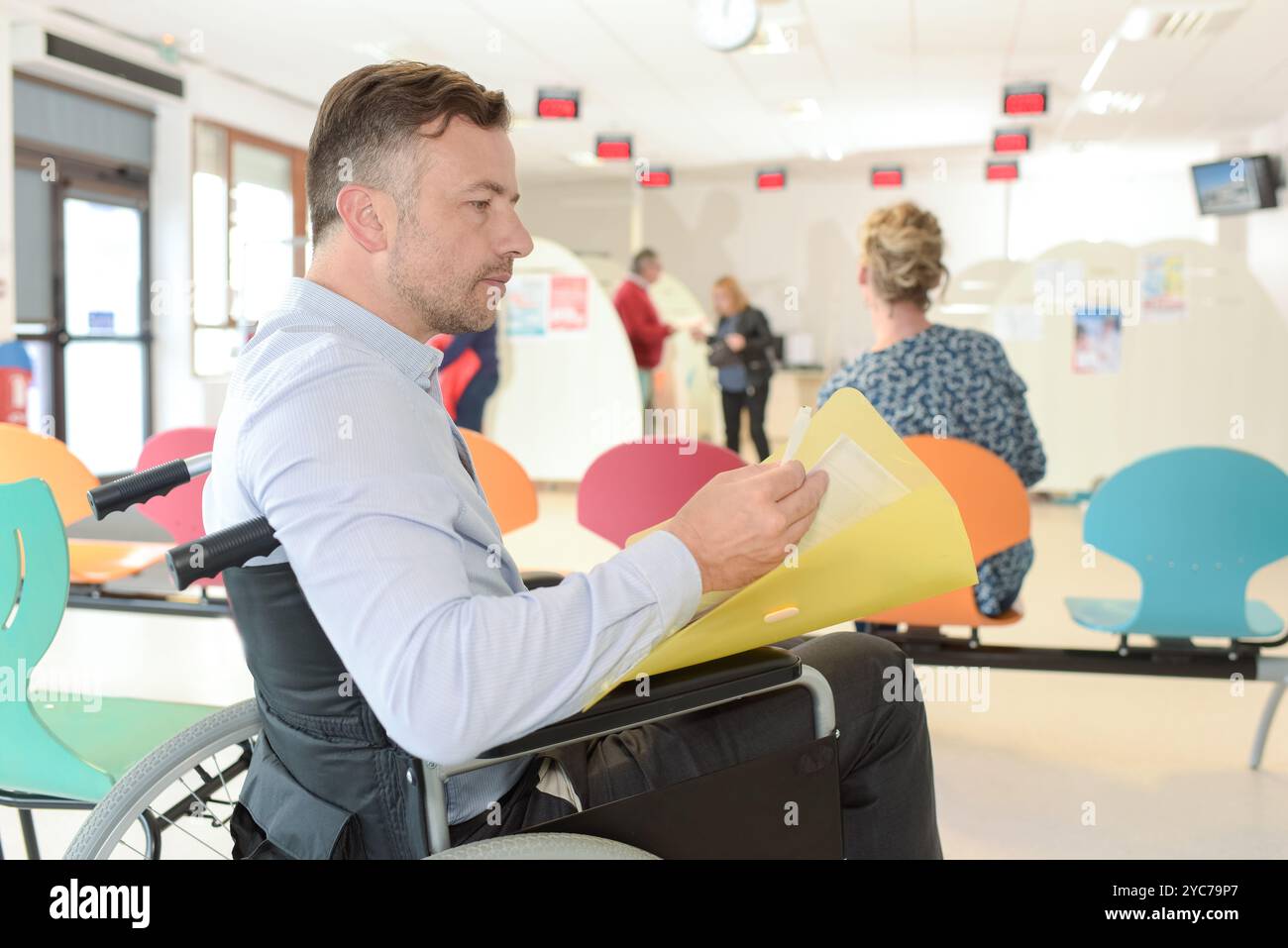 man reading documents while waiting Stock Photo - Alamy