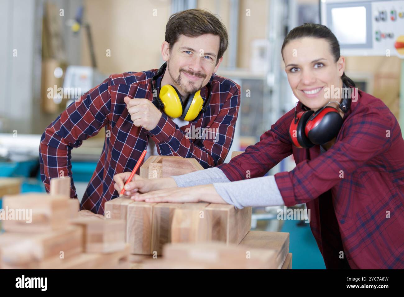 carpenter training female apprentice to use plane Stock Photo - Alamy