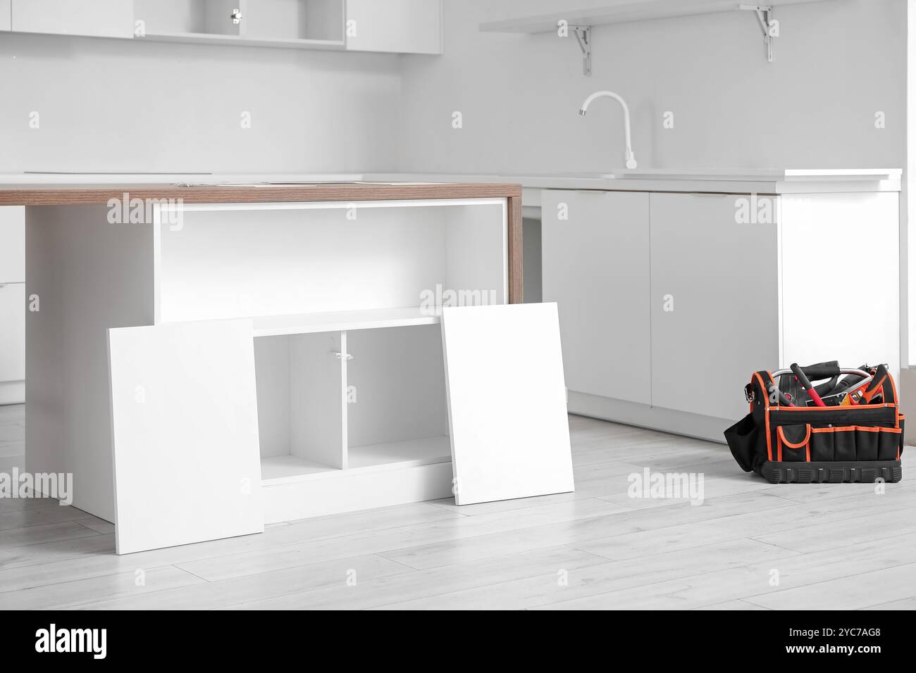 Interior of light kitchen with counters, table and tool bag Stock Photo ...