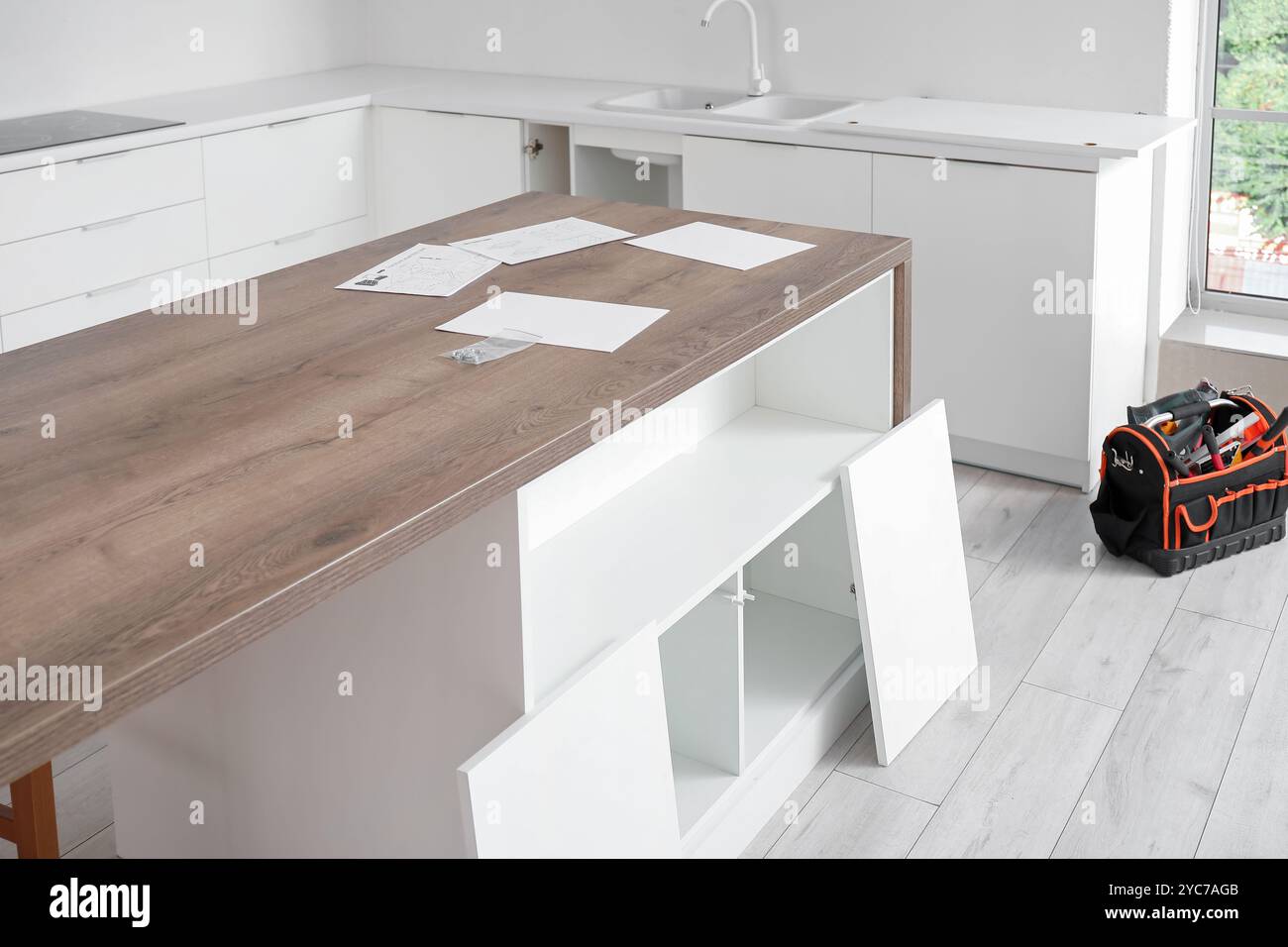 Interior of light kitchen with counters, table and tool bag Stock Photo ...