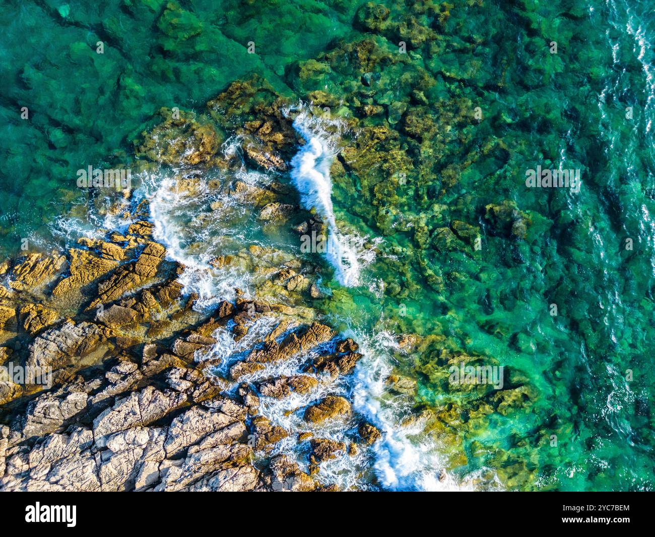 Aerial view of sharp rocks on Punta Planka, Croatia, splashed with ...