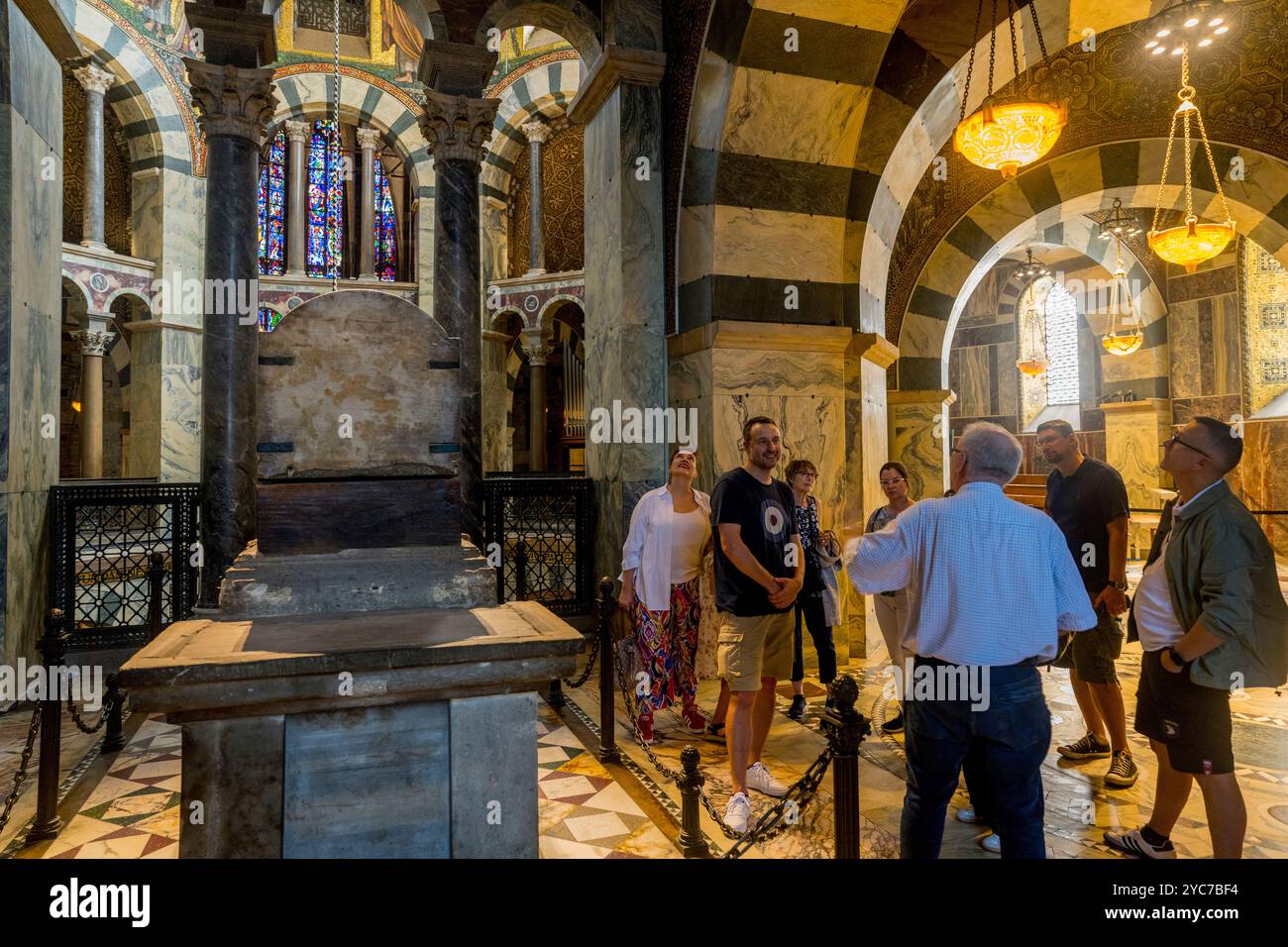 A tour group at the throne of Charlemagne in the Aachen Cathedral (UNESCO’s World Heritage Site ...