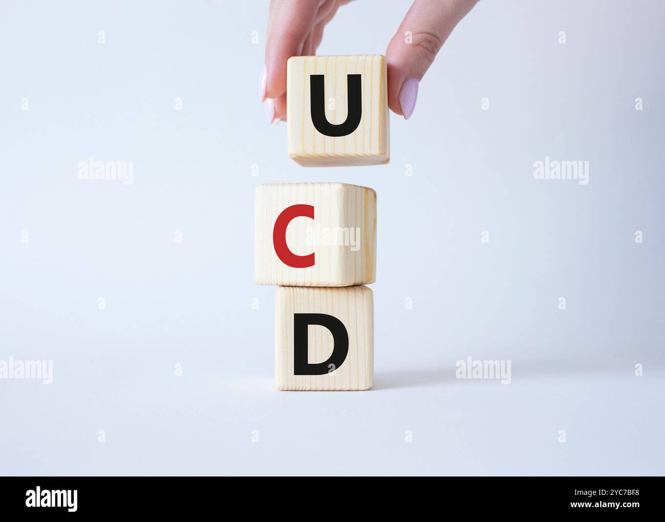 UCD - User Centered Design. Wooden cubes with word UCD. Businessman ...