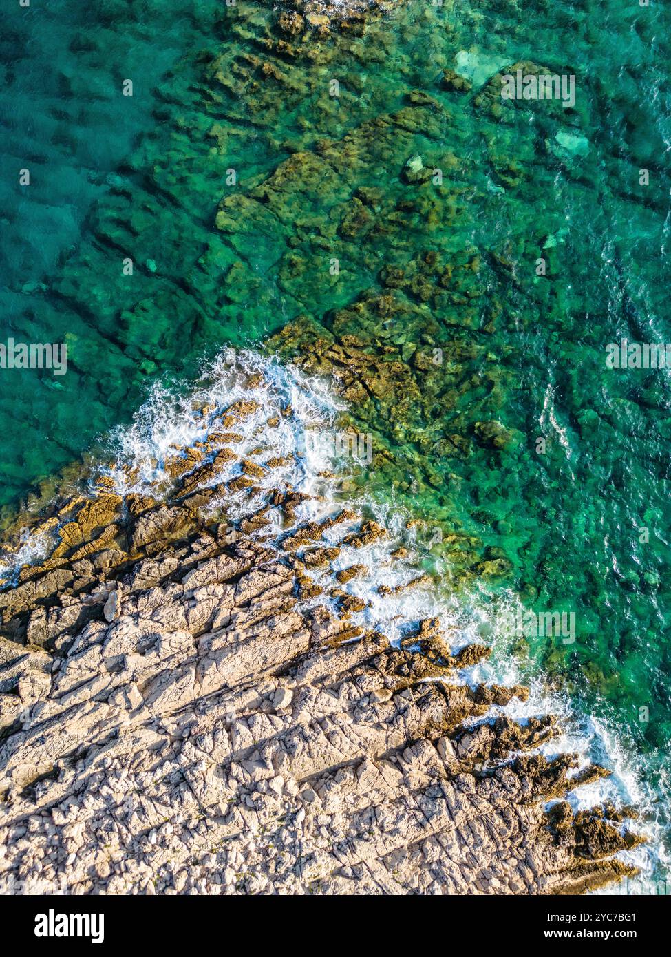 Aerial view of sharp rocks on Punta Planka, Croatia, splashed with ...