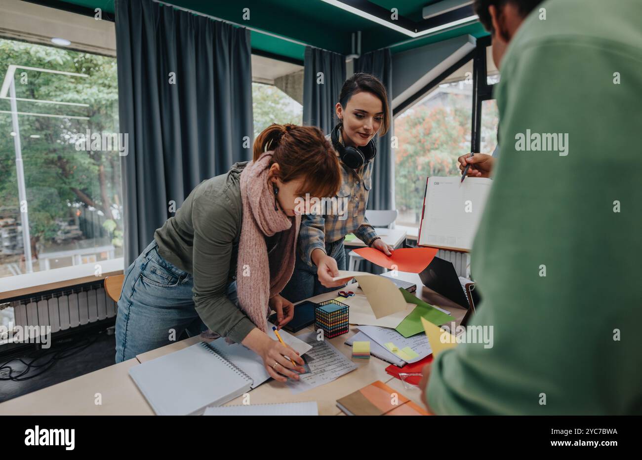 Students collaborating on school tasks in a modern classroom setting ...
