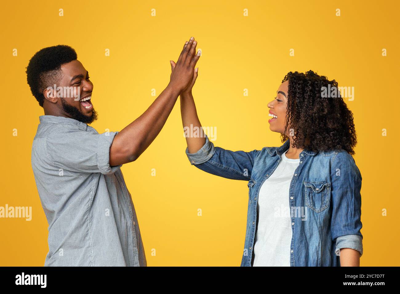 Common Success. Happy african american couple giving high-five ...