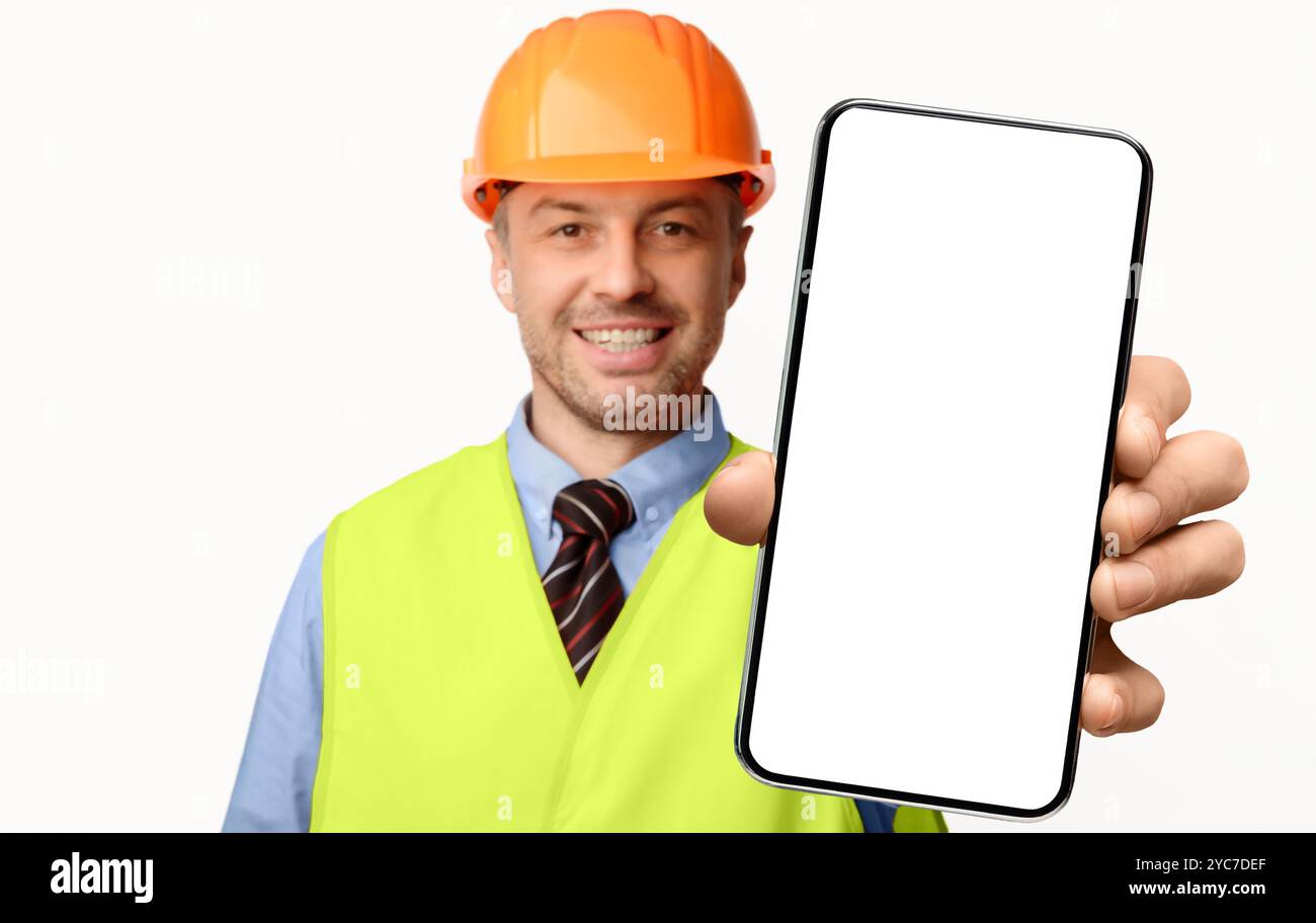 Construction Worker Showing Cellphone Screen On White Studio Background ...