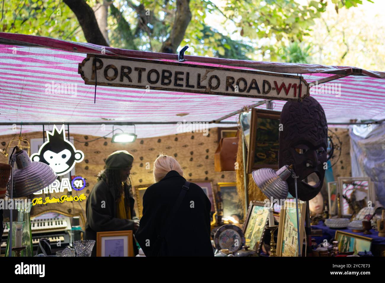 Woman shopping at antique stall, Portobello Road Market, London Stock ...